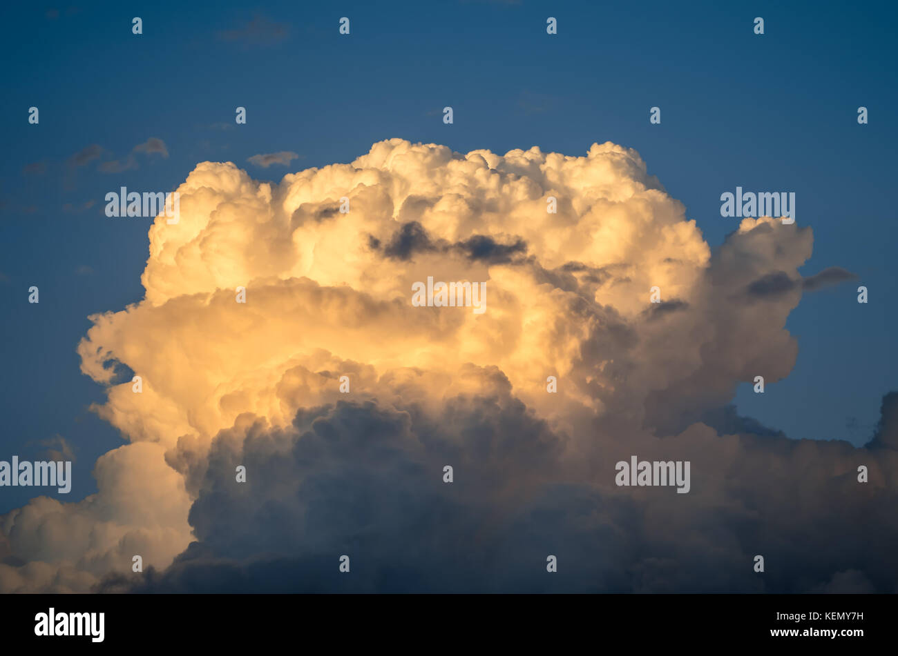 A photograph of dramatic clouds lit by the sun on a blue sky Stock ...