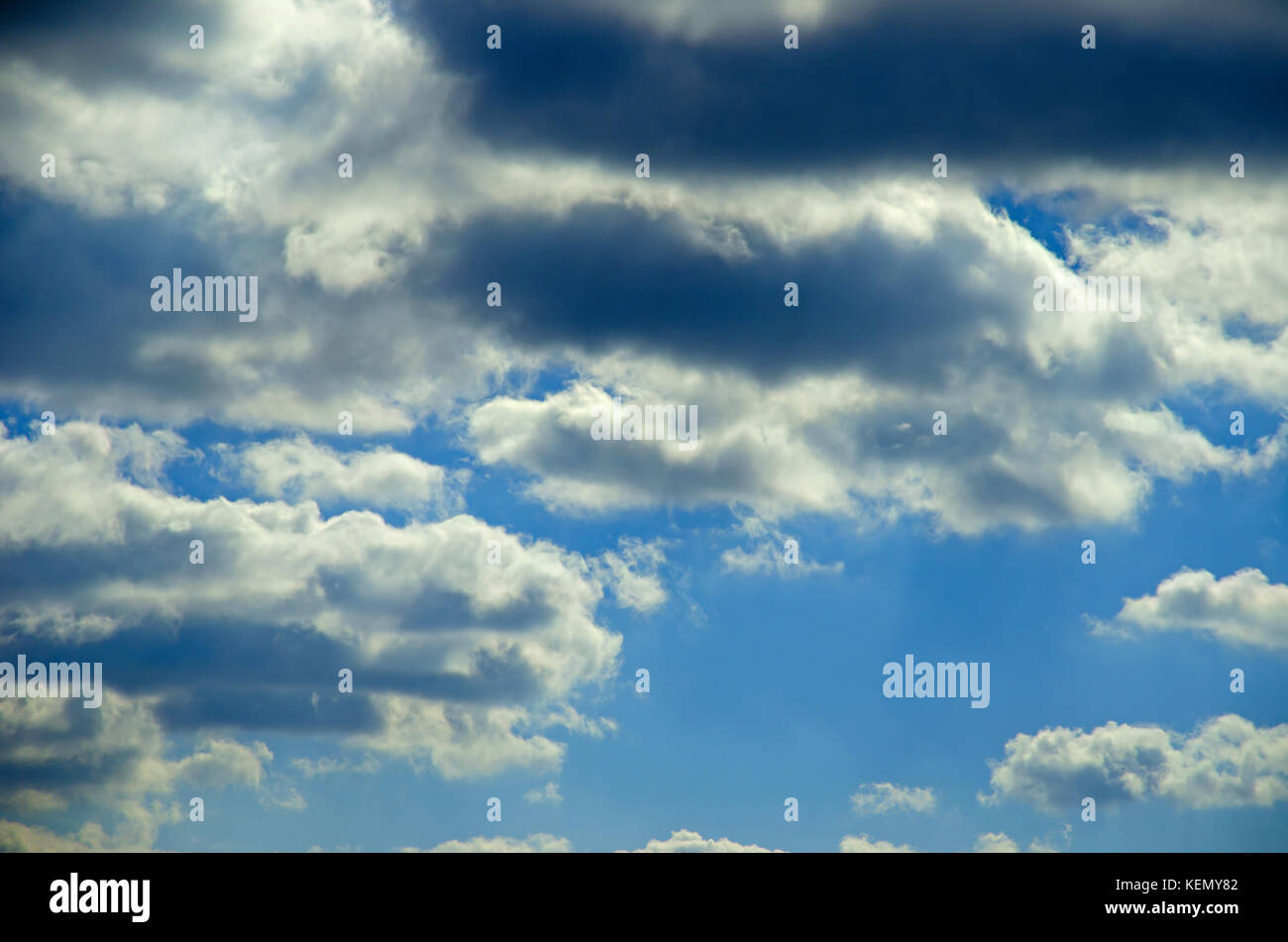 View of spring blue sky with clouds illuminated by the sun before the ...