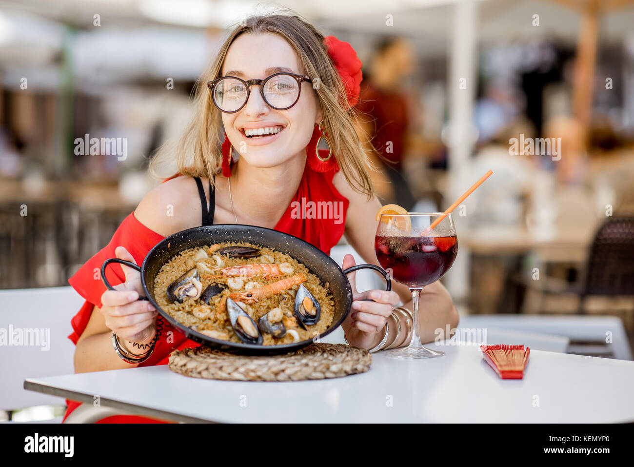 Woman eating Paella dish at the restaurant Stock Photo - Alamy