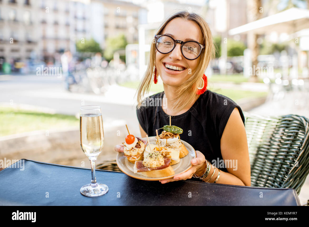 Woman eating spanish pinchos at the bar outdoors Stock Photo - Alamy