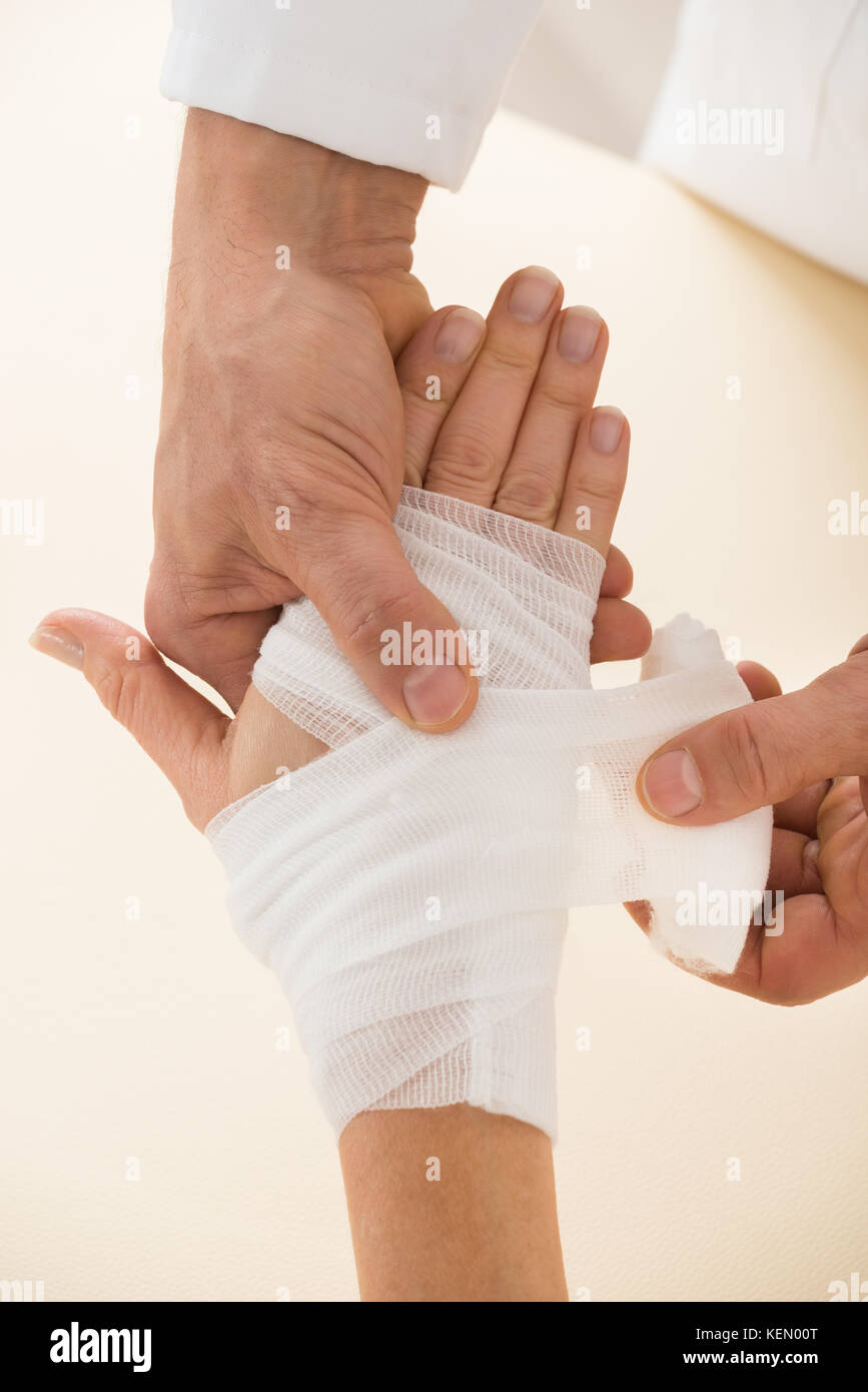 Close-up Of Person Hand Wrapping Bandage To Patient Stock Photo - Alamy