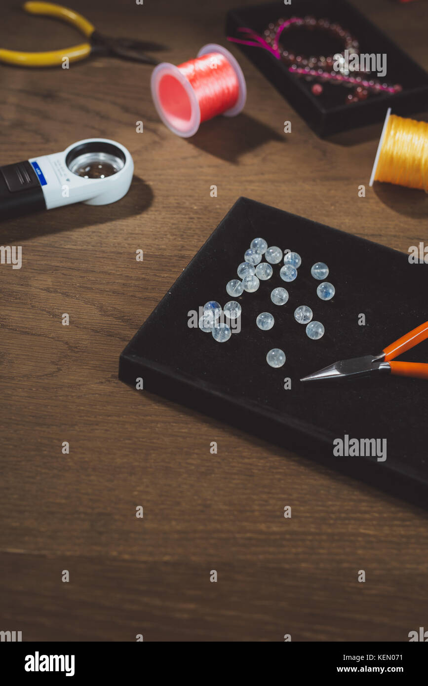 Tools for jewelry making, colorful stone beads. Jewellry workplace ...