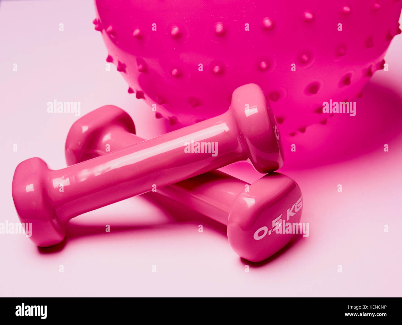 pink dumbbells on a pink background Stock Photo - Alamy