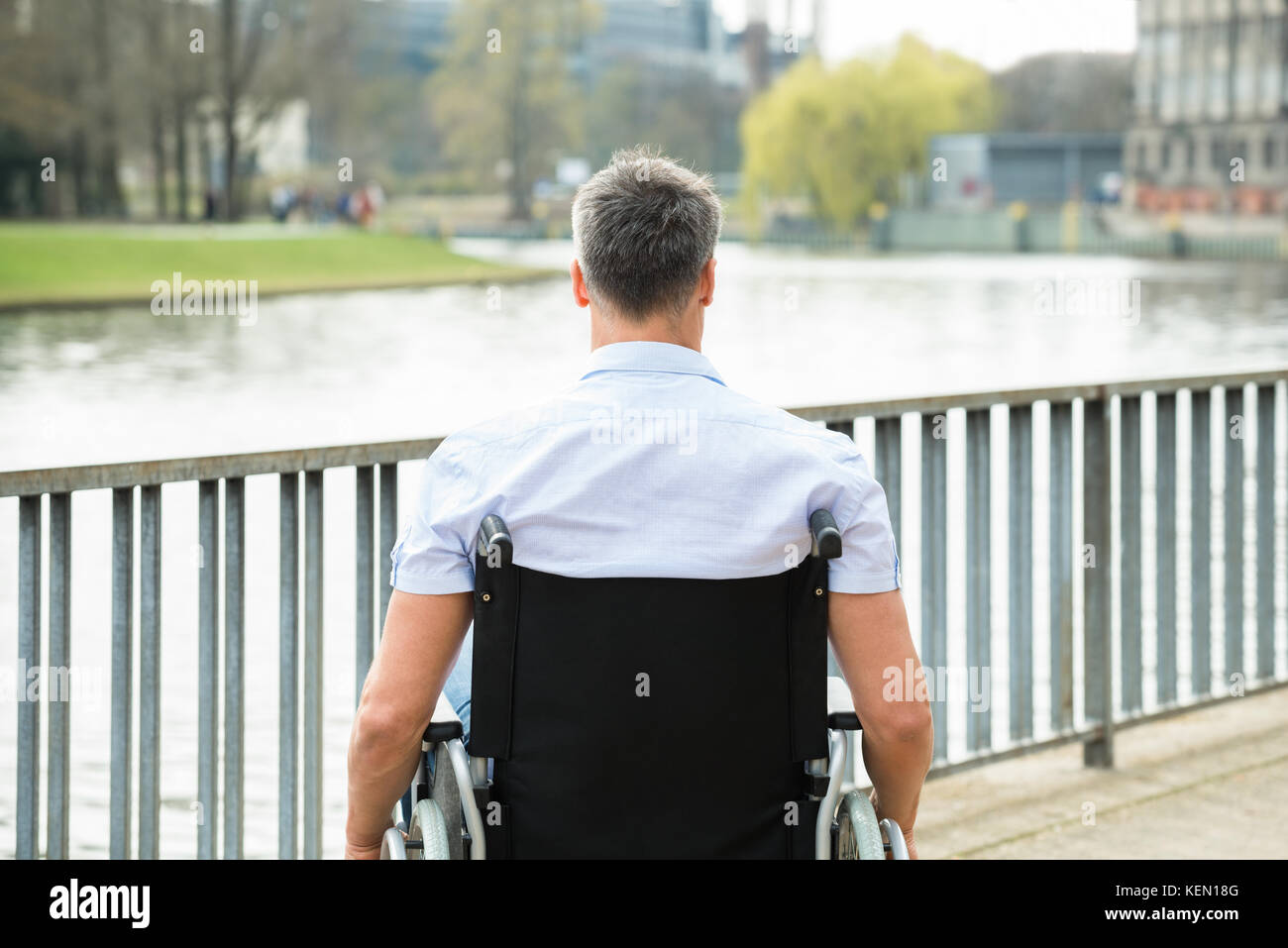 Rear View Of Disabled Man On Wheelchair Looking At Lake Stock Photo - Alamy
