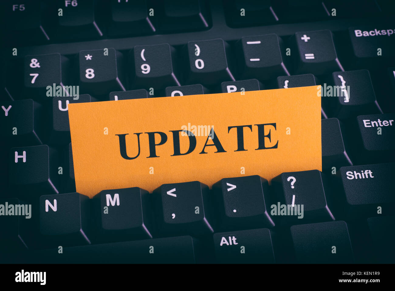 Yellow paper note on black keyboard with writing Update. Close up Stock ...