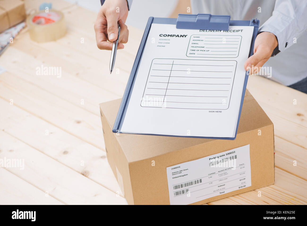 Delivery man presenting receiving form in post office Stock Photo - Alamy