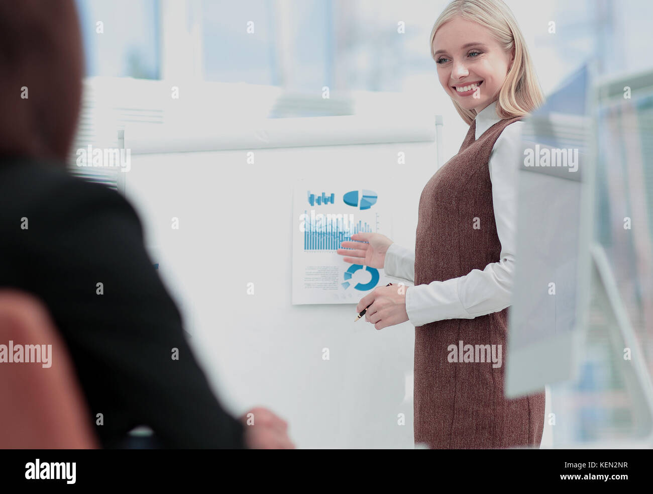 Attractive woman making a business presentation to a group Stock Photo ...