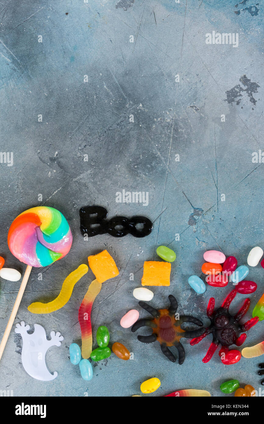 Trick and treat - halloween scary candies border on gray stone with ...