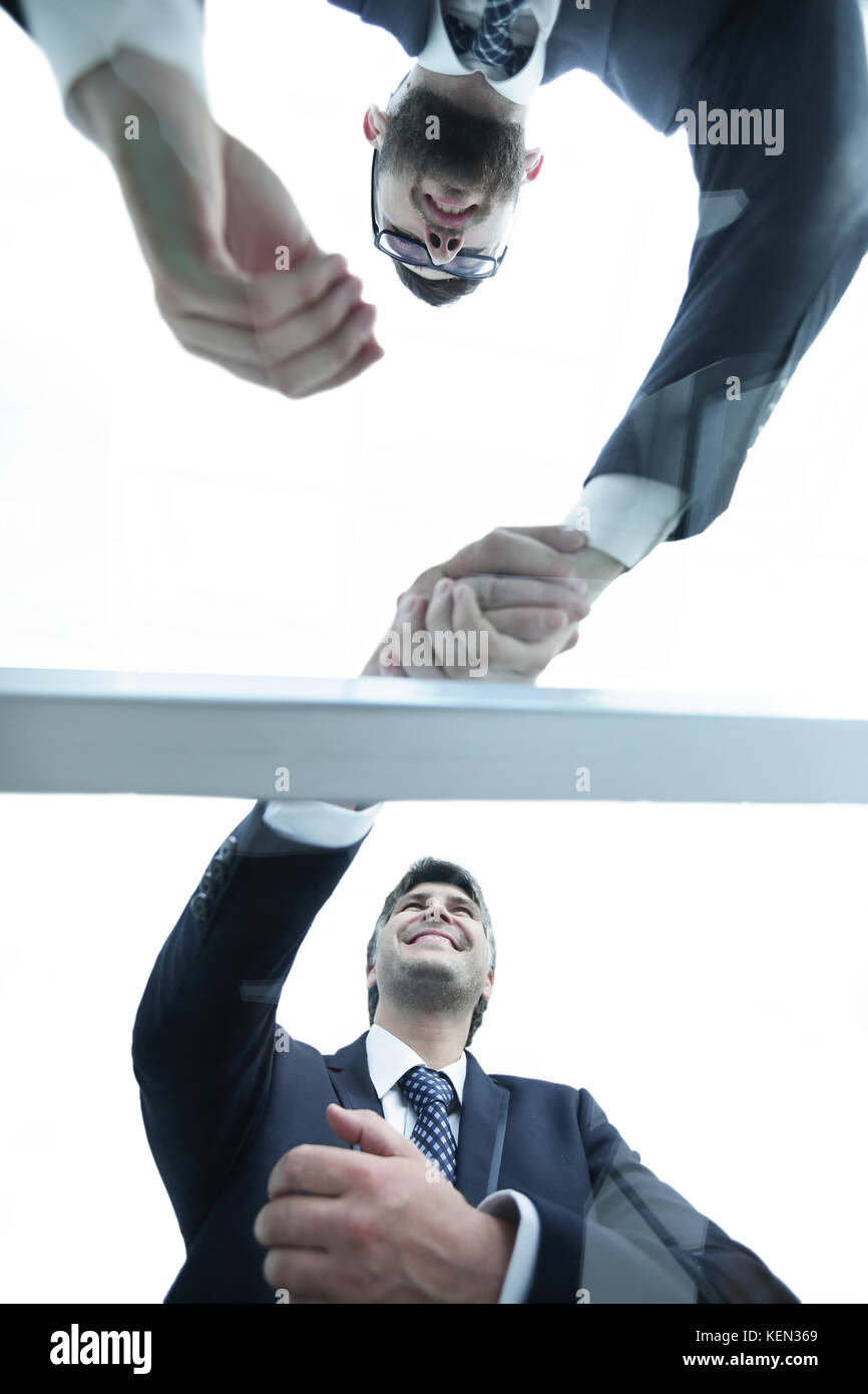 View from below. From behind the glass. Handshake of business partners ...