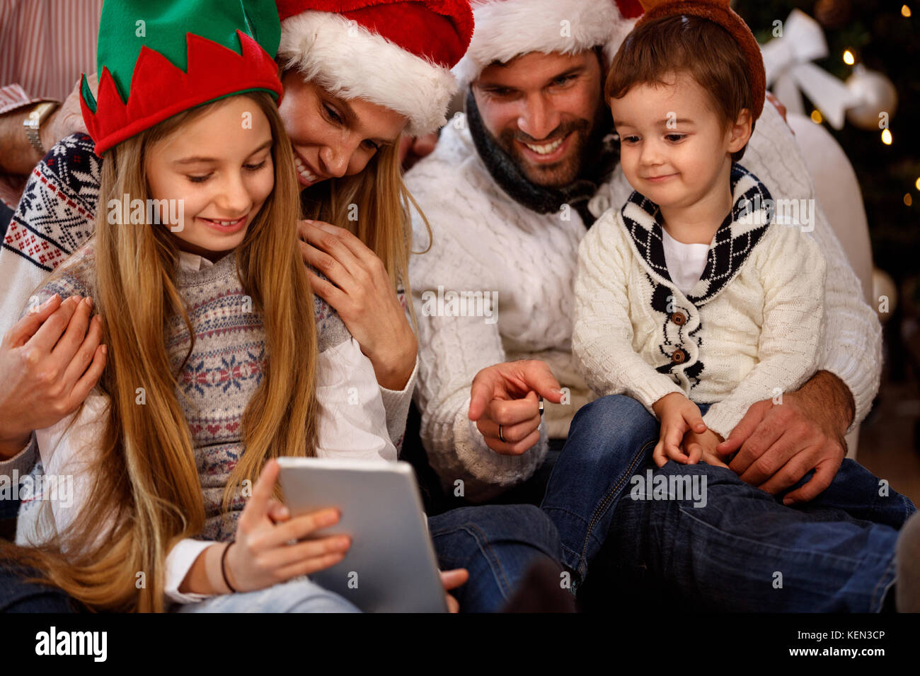 Children with parents looking something interesting on tablet Stock ...