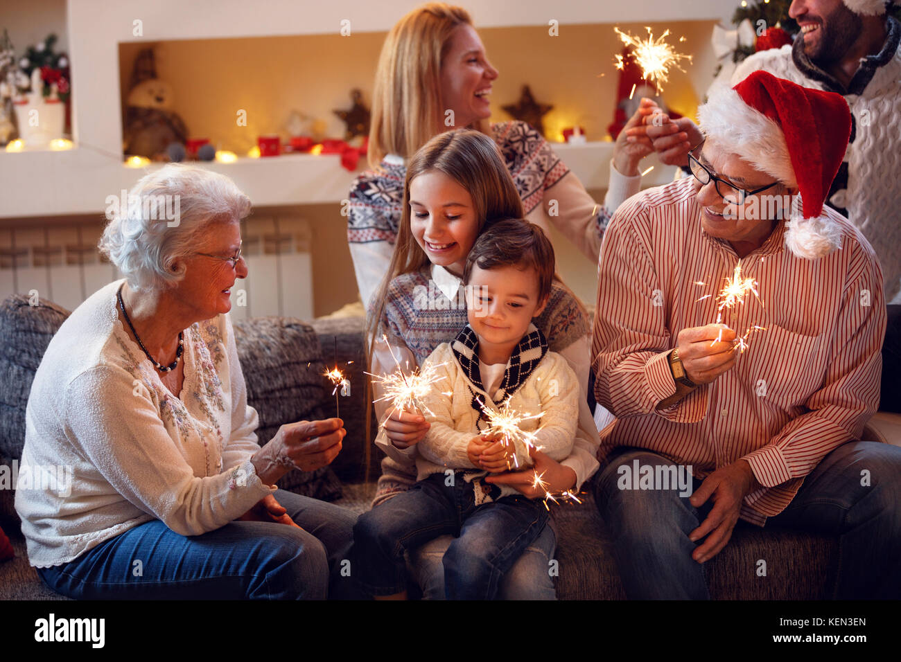 Cheerful grandparents with children celebrating New Year Stock Photo ...