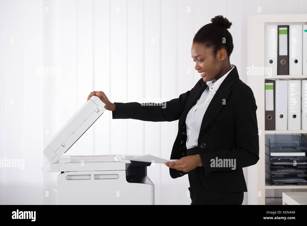 Smiling Young African Businesswoman Placing Paper On Photocopy Machine ...