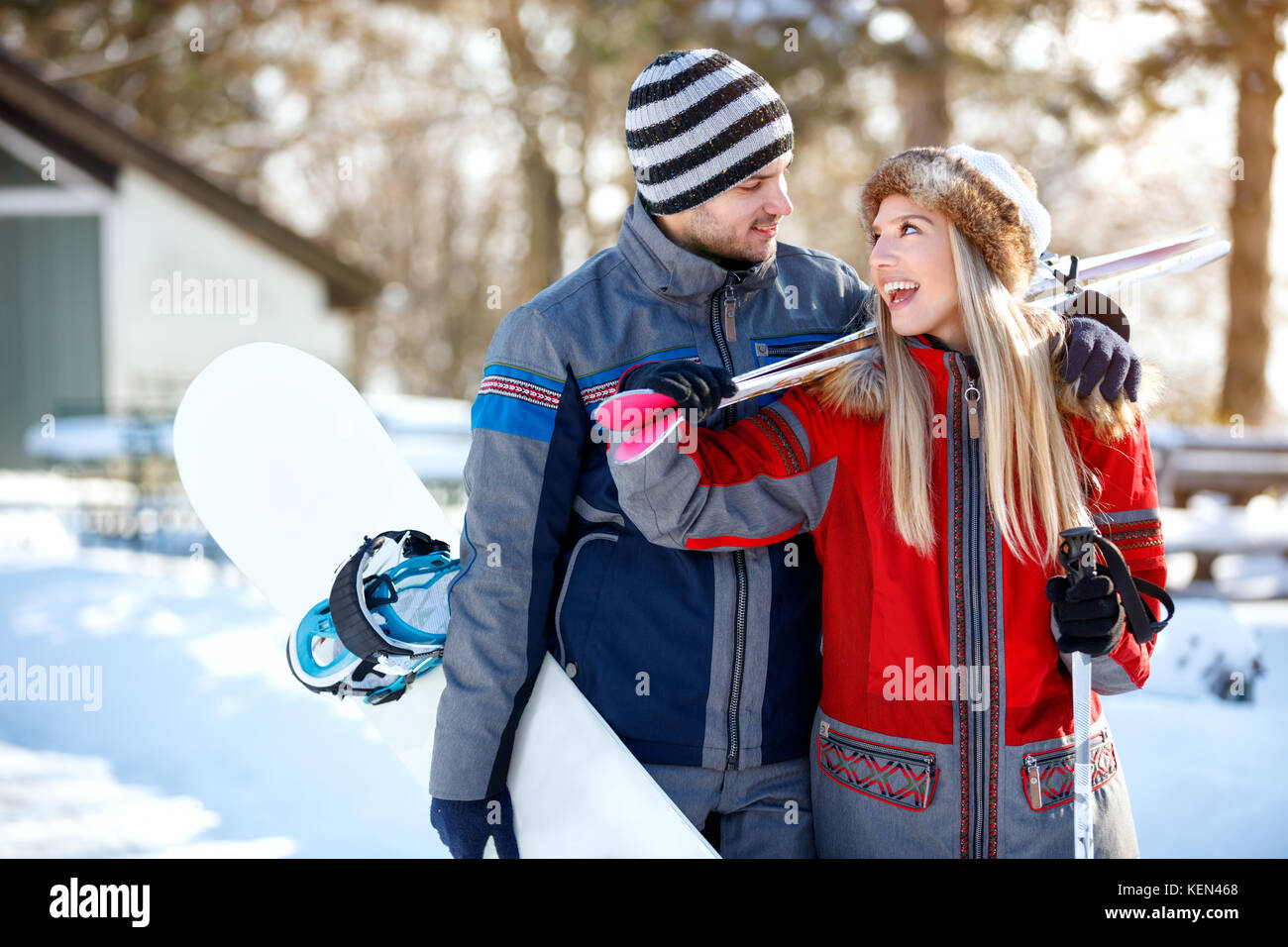Cheerful young skiers couple going to ski terrain Stock Photo - Alamy