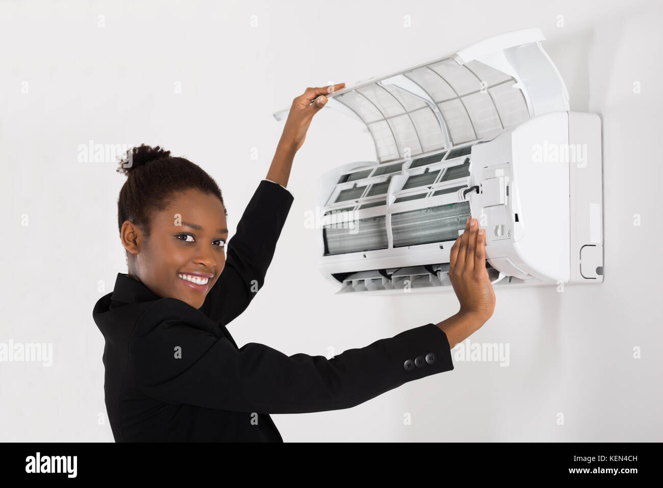 Young Happy African Businesswoman Checking Air Conditioner In Office ...