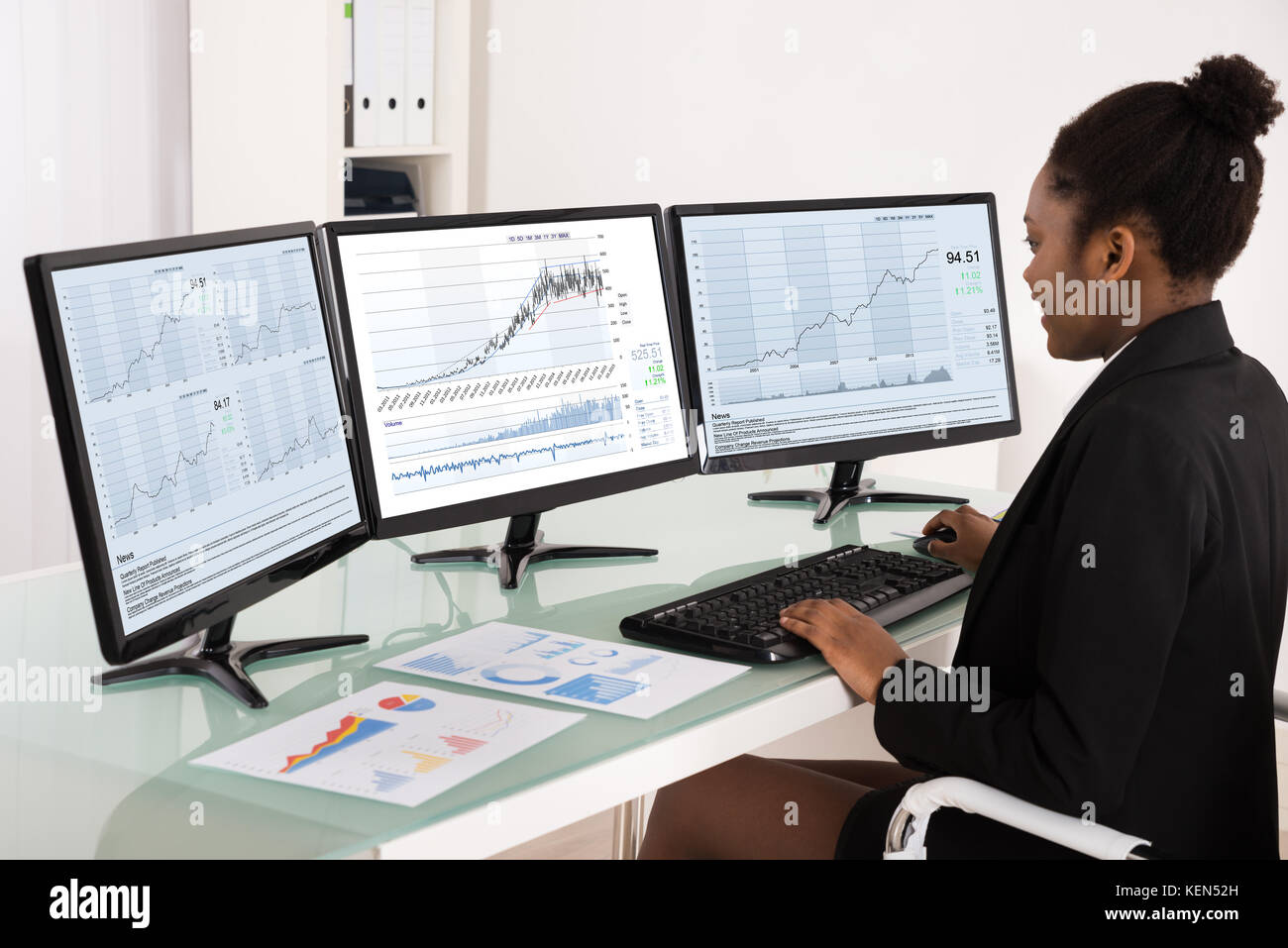 Young African Businesswoman Analyzing Data On Multiple Computer Screen ...