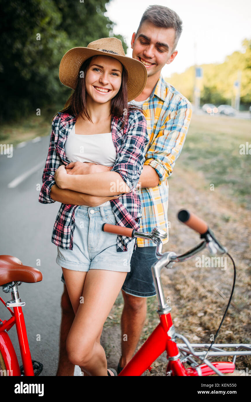 Couple hugs in park, vintage bike, romantic date Stock Photo - Alamy