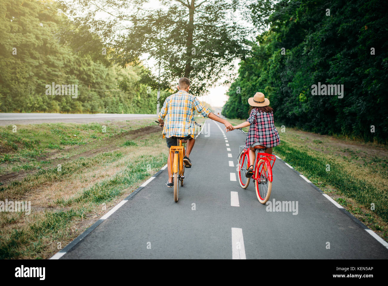 Love couple riding on vintage bikes Stock Photo - Alamy