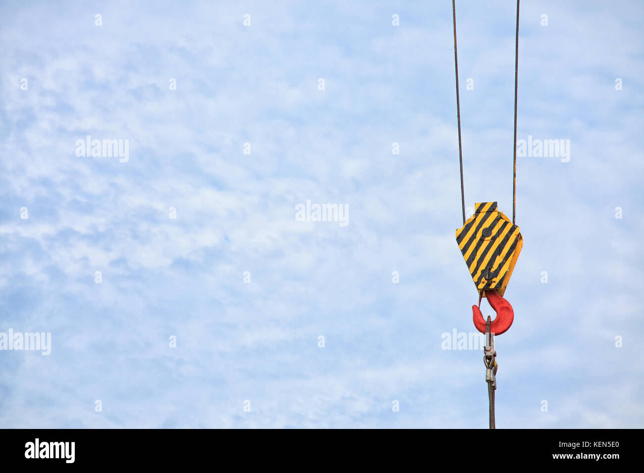 Yellow lifting hook on the cable, with a free place for the inscription ...