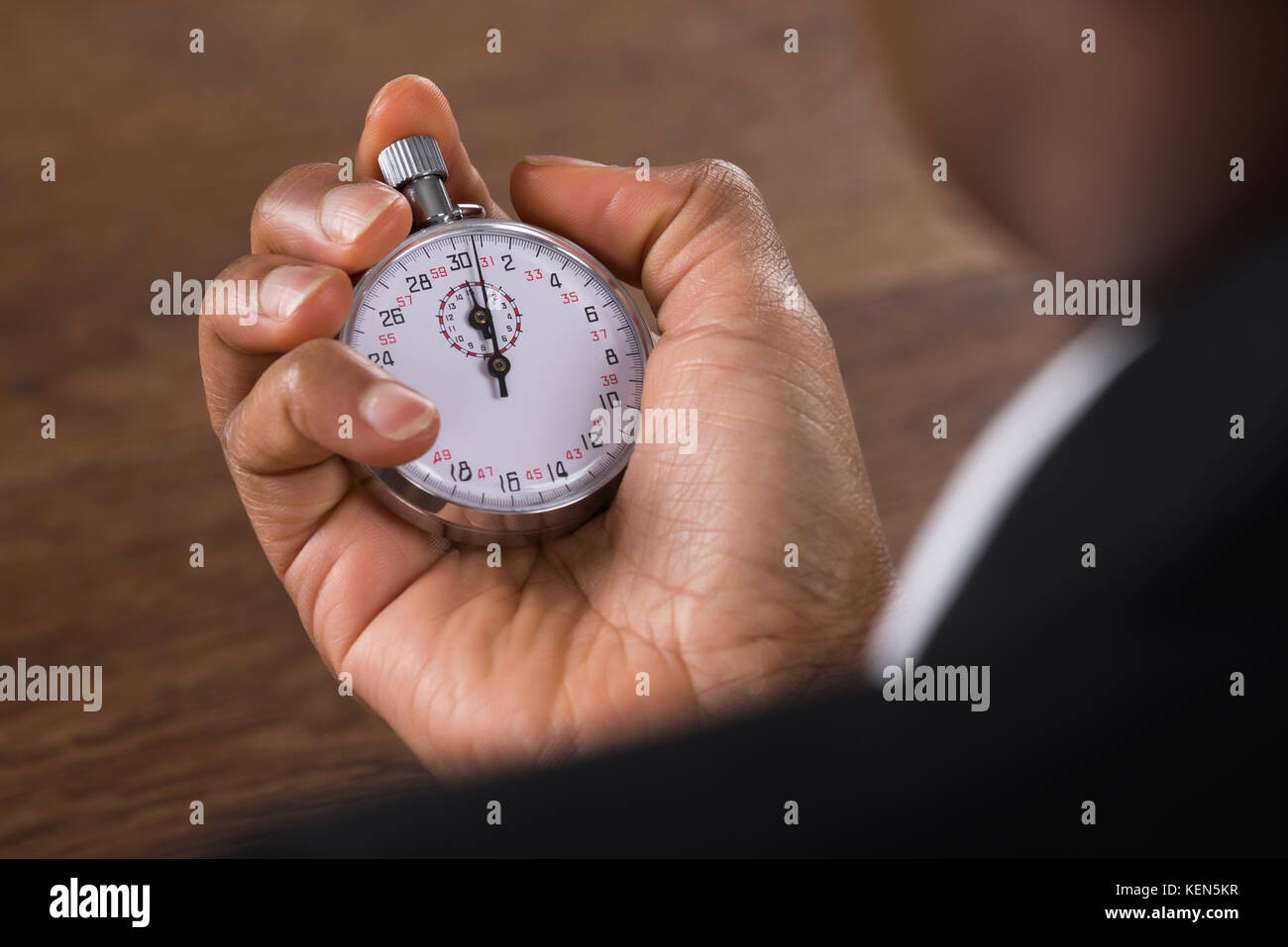 Close-up Of A Businessperson Hand Holding Stop Watch Stock Photo - Alamy