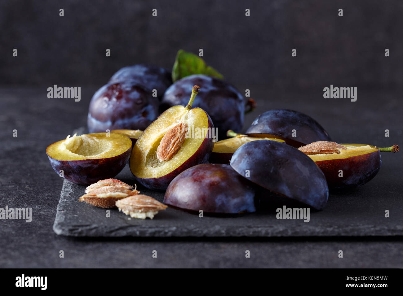 Freshly picked organic plums on dark table background Stock Photo - Alamy