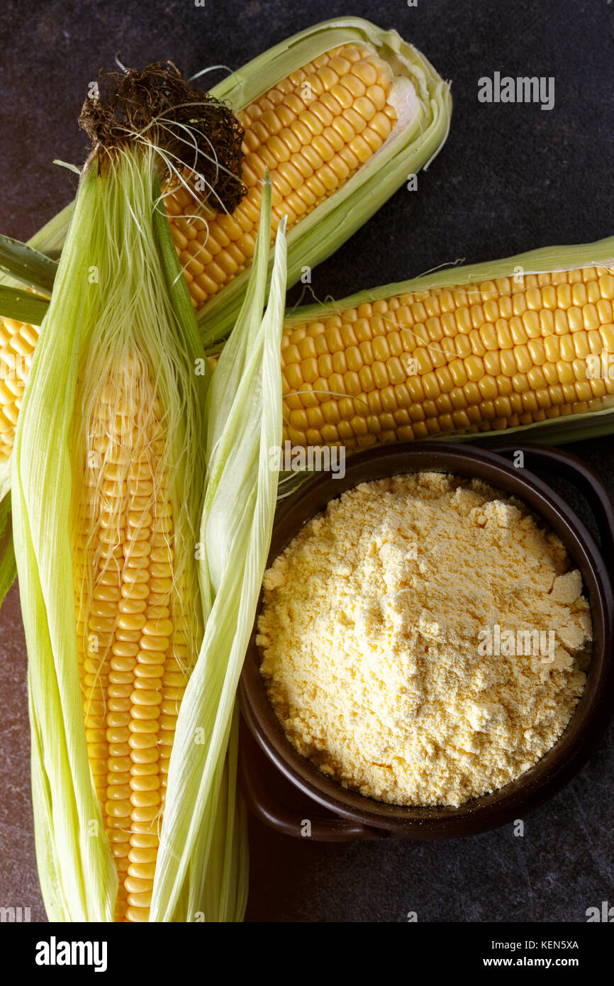 Fresh Corn and corn grits in bowl on black table background Stock Photo ...