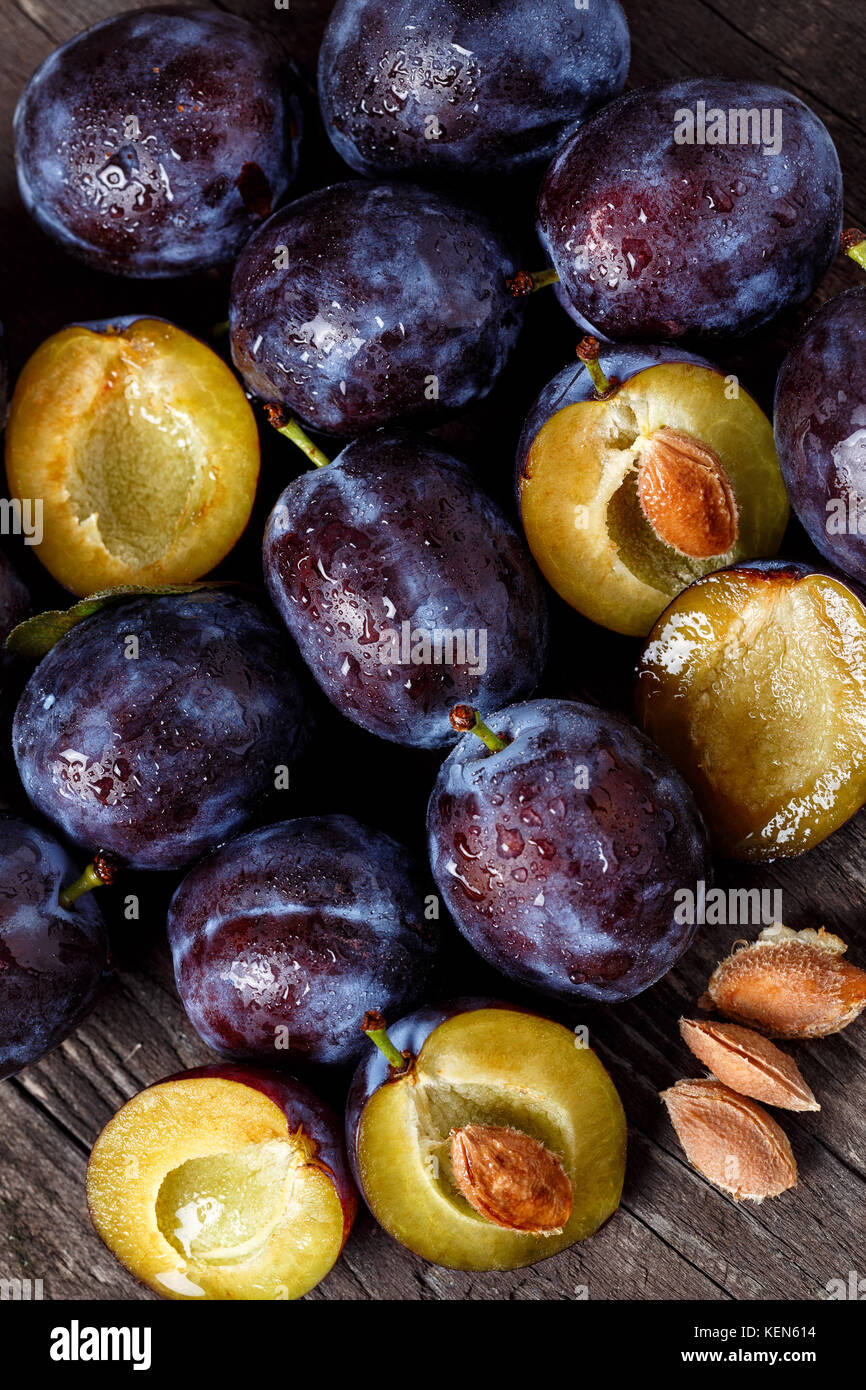 top view on fresh raw plums on wooden table background Stock Photo - Alamy