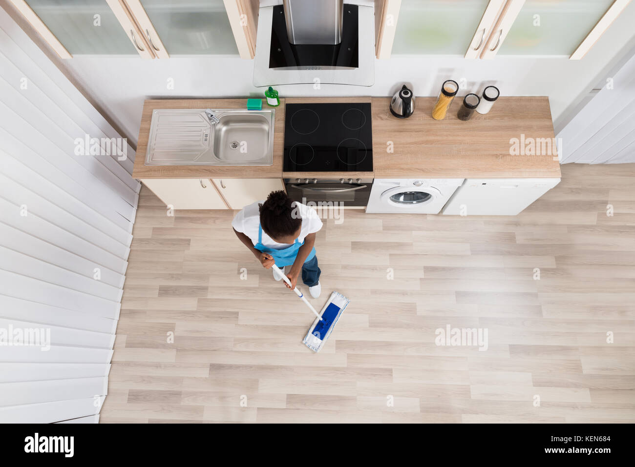 High Angle View Of Young Female Janitor Cleaning Floor In Kitchen Stock ...