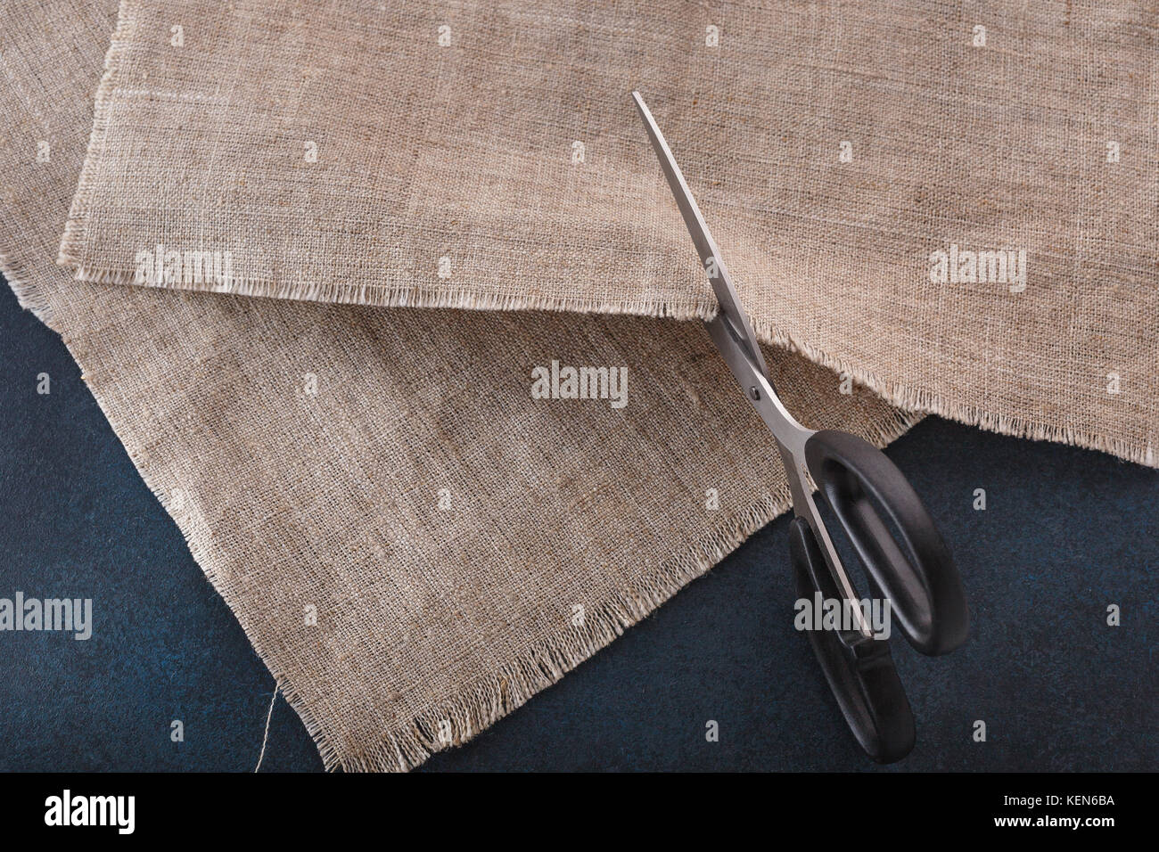 The tailor's scissors cut linen cloth Stock Photo - Alamy