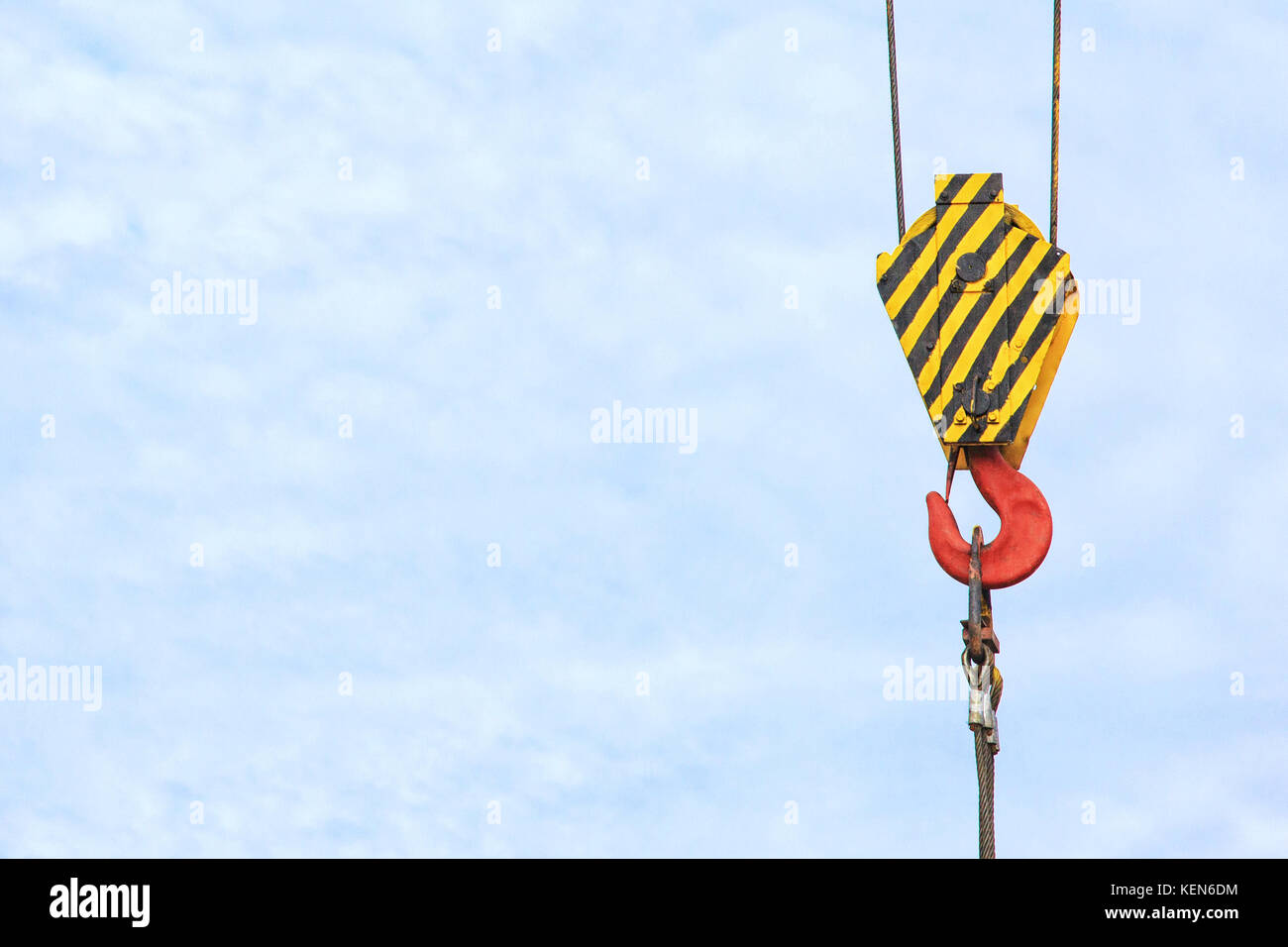 Yellow lifting hook on the cable, with a free place for the inscription ...