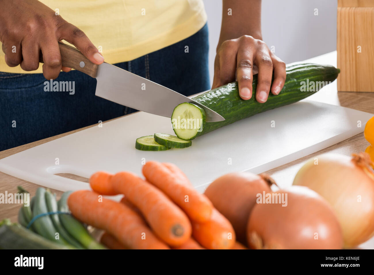 Close-up Of Woman's Hand Chopping Vegetables With Knife In Kitchen ...