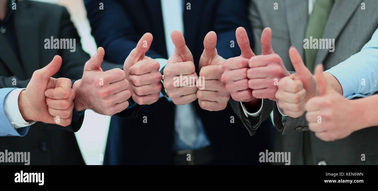 Cheering business people holding many thumbs thumbs up Stock Photo - Alamy