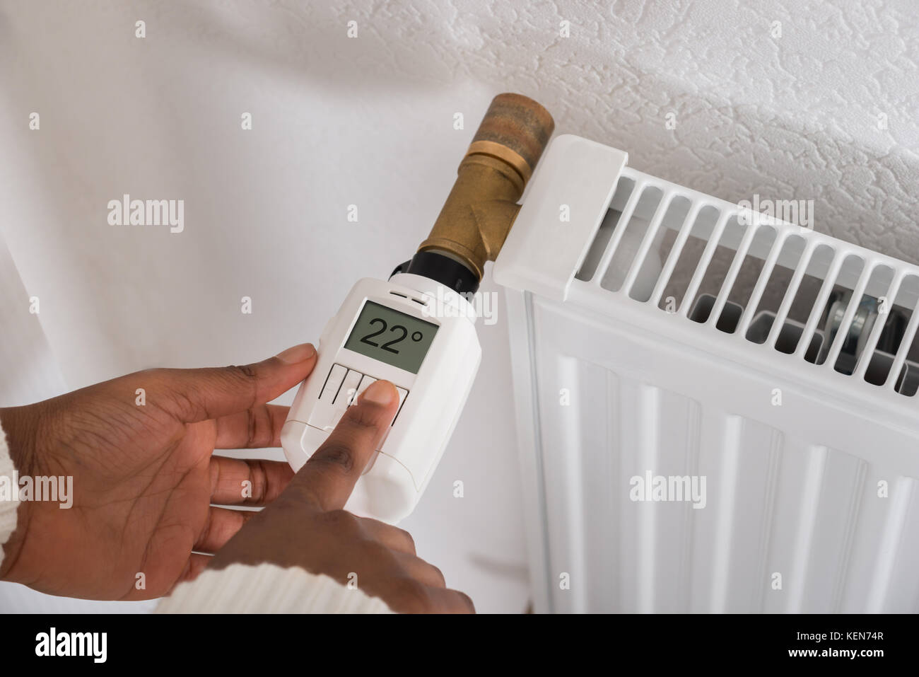 Close-up Of A Woman's Hand Adjusting Temperature On Thermostat Stock ...