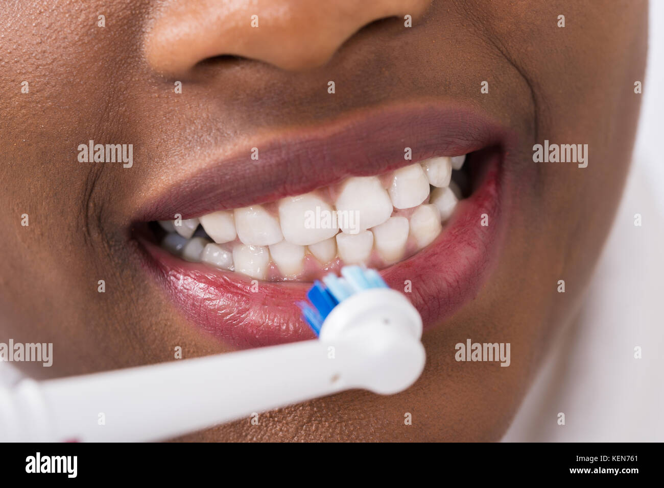 Close-up Of A Woman Brushing Teeth With Electric Toothbrush Stock Photo ...