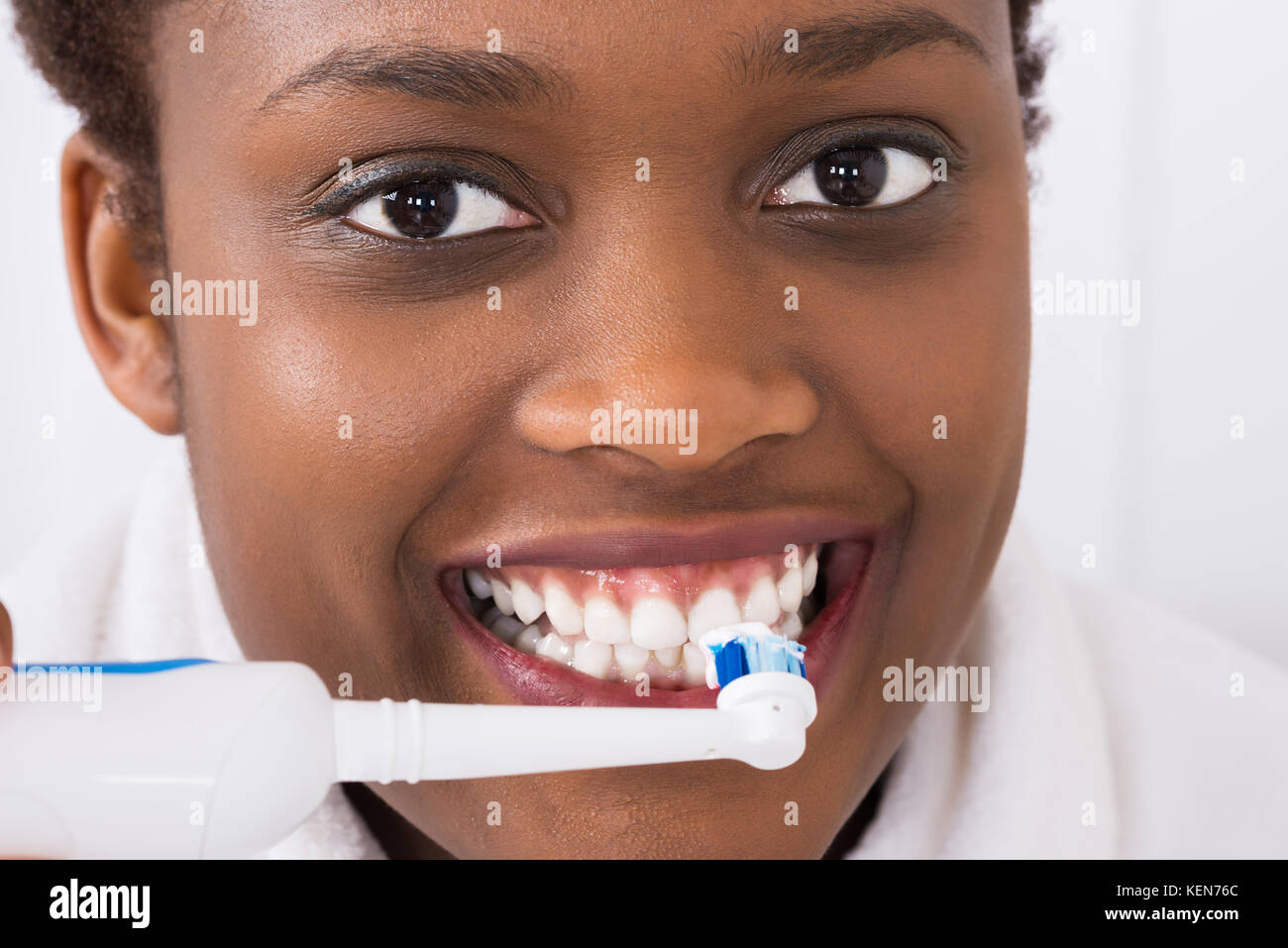 Close-up Of An African Woman Brushing Teeth With Electric Toothbrush ...