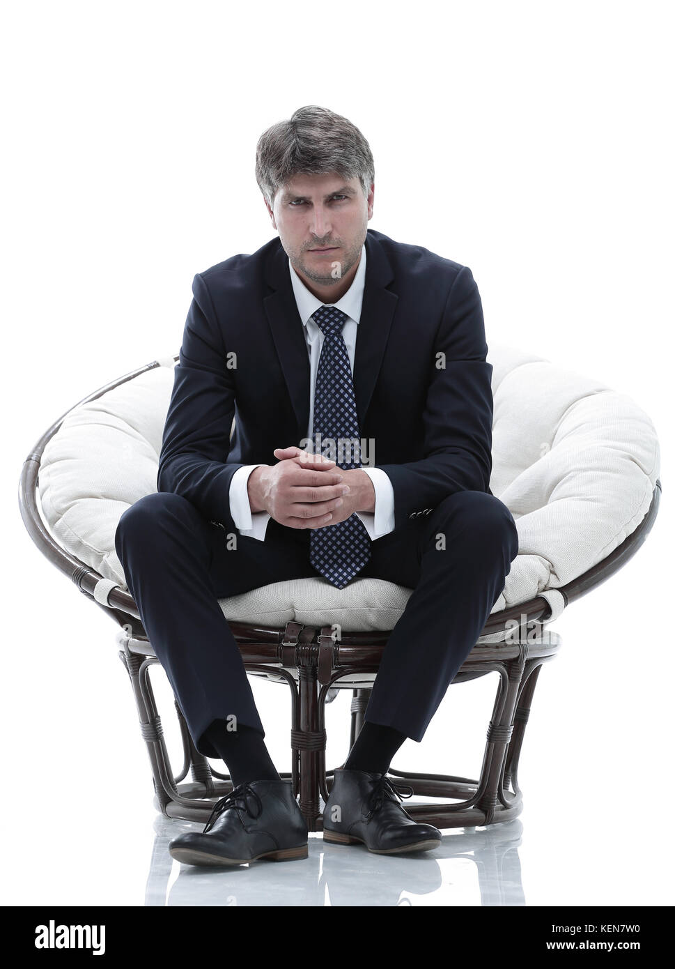 Tired business man sitting in a large comfortable chair Stock Photo - Alamy