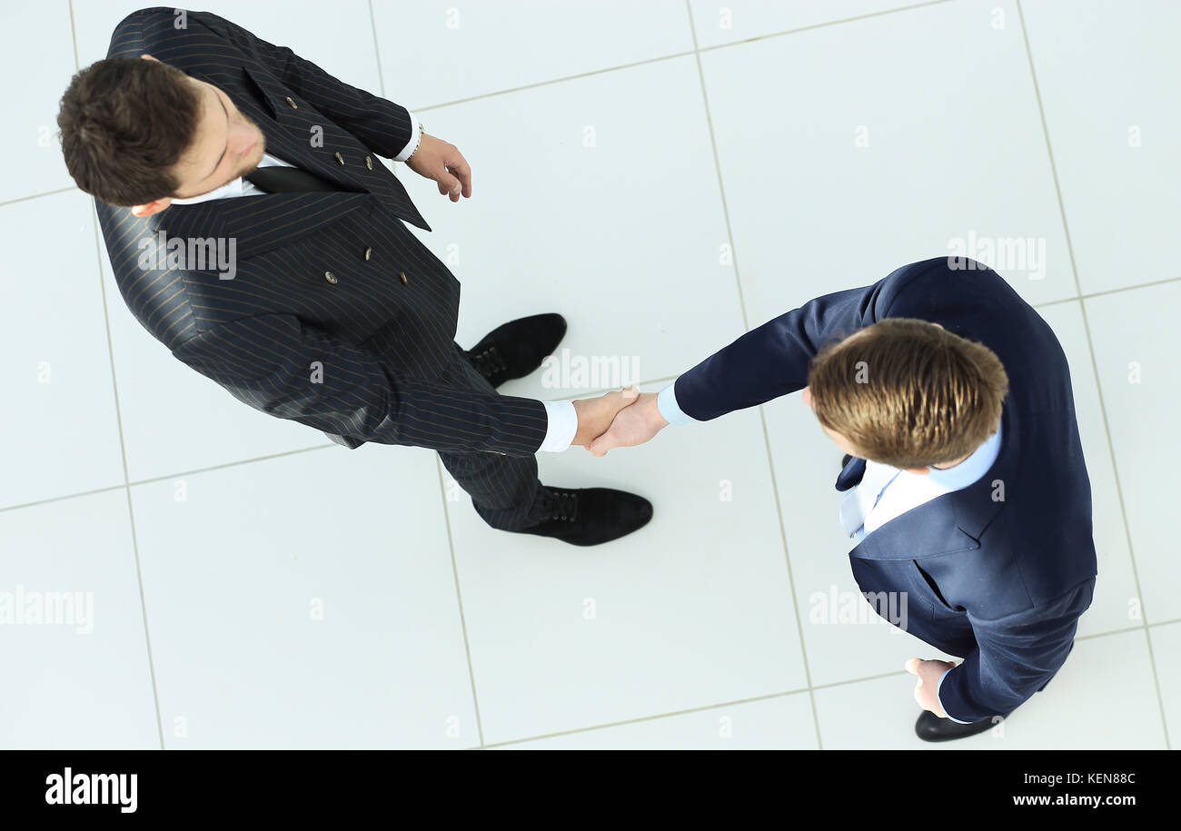 view from the top.handshake, business partners ,isolated on white ...