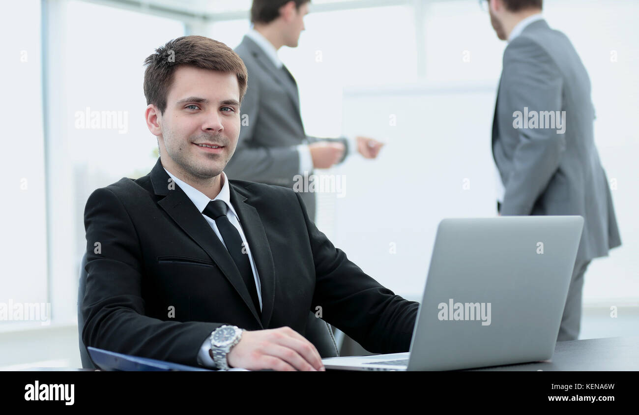 in the foreground is a successful businessman sitting at the table in ...