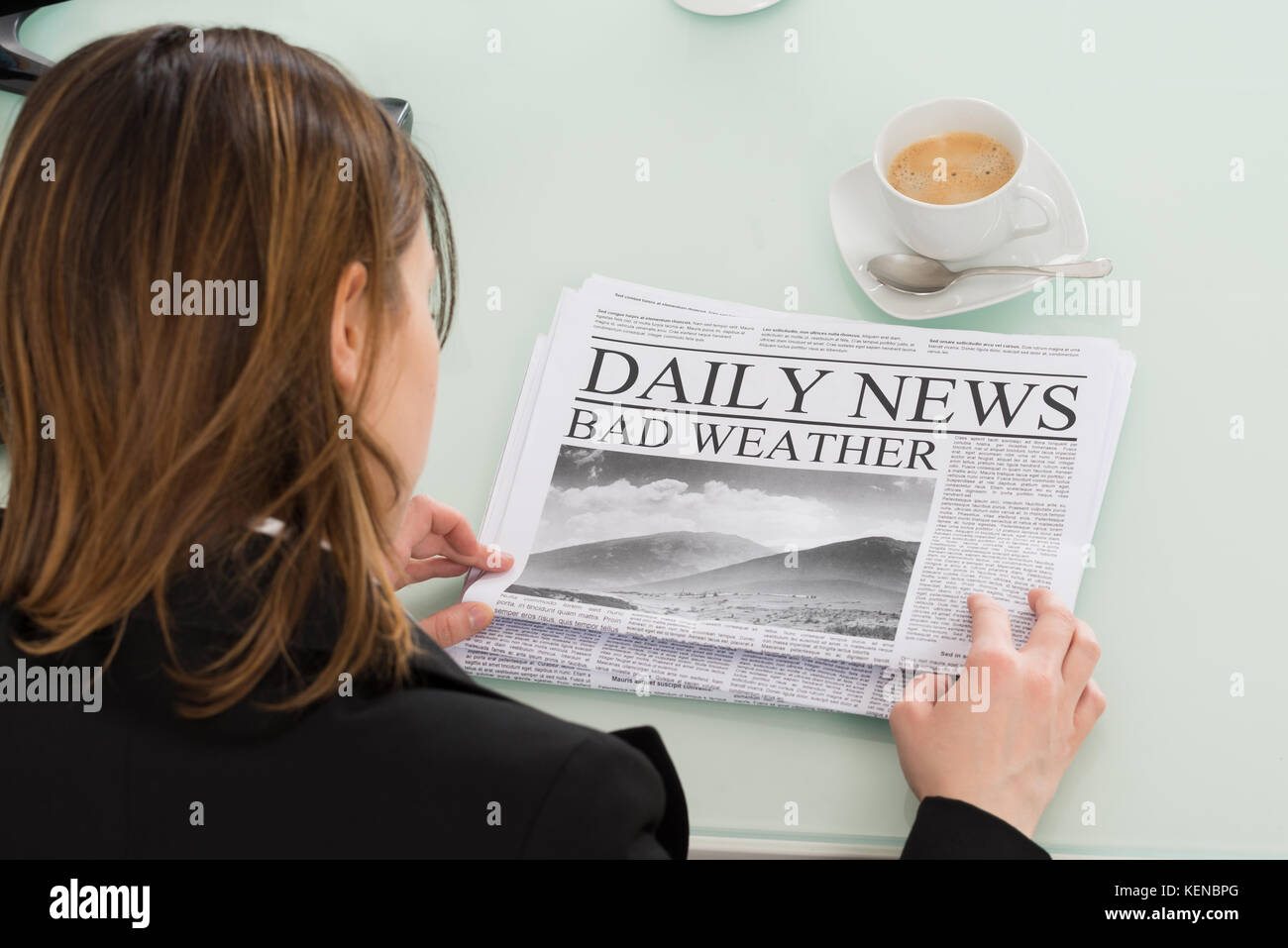 Young Businesswoman Reading Weather News On Newspaper In Office Stock ...