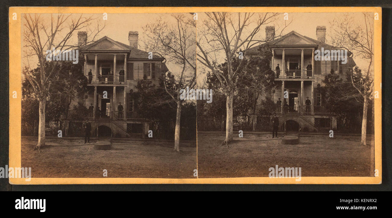 View of a large house with civil and military personnel on porches ...
