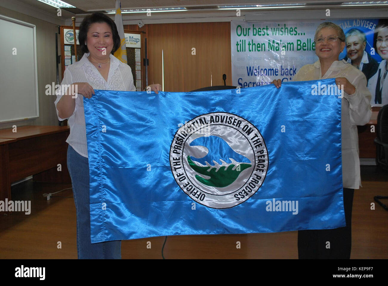 Outgoing Secretary Annabelle Abaya turns over the official flag of the ...