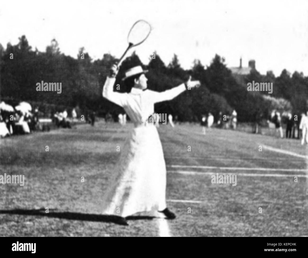 Muriel Robb is seen serving in a competitive tennis match, showcasing ...