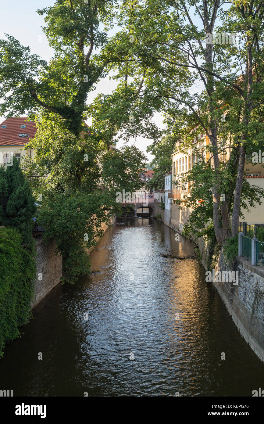 Old buildings, verdant trees, bridge and water canal on the Kampa ...