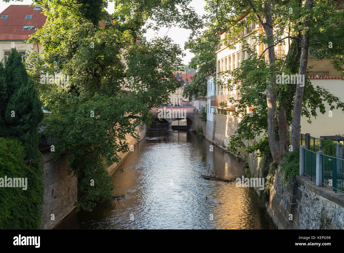 Old buildings, verdant trees, bridge and water canal on the Kampa ...