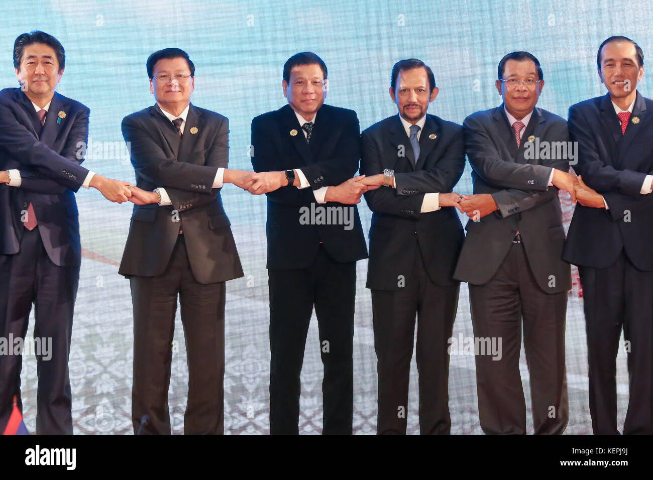 ASEAN heads of states holding hands 090716 Stock Photo - Alamy