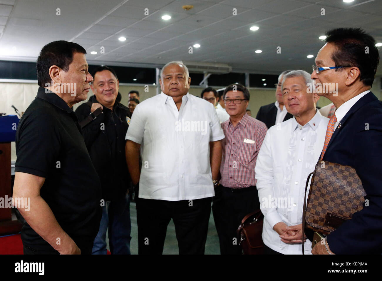 Rodrigo Duterte is in a huddle with his Cabinet members at the ...