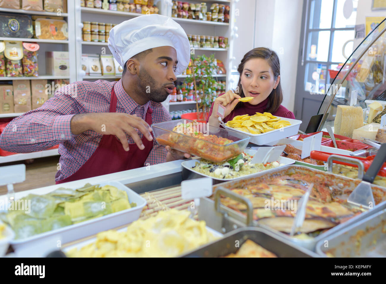 bakery shopkeeper gives pastry to customer Stock Photo - Alamy