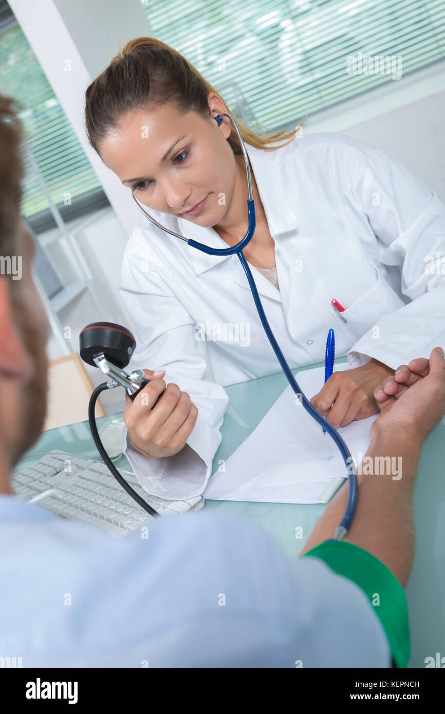 doctor testing blood pressure to a senior patient Stock Photo - Alamy