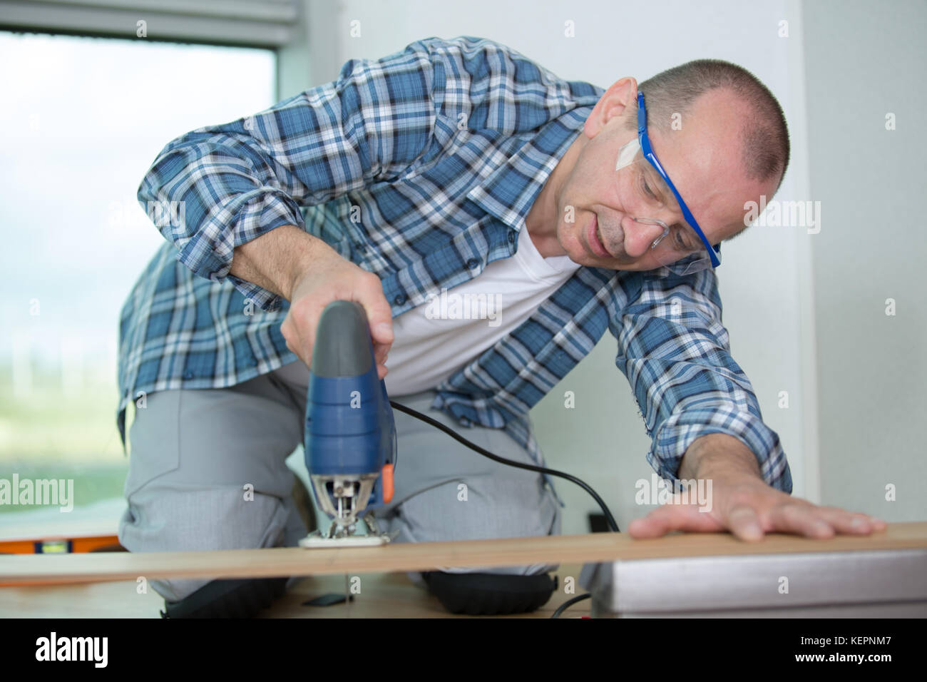 carpenter cutting wood board Stock Photo - Alamy