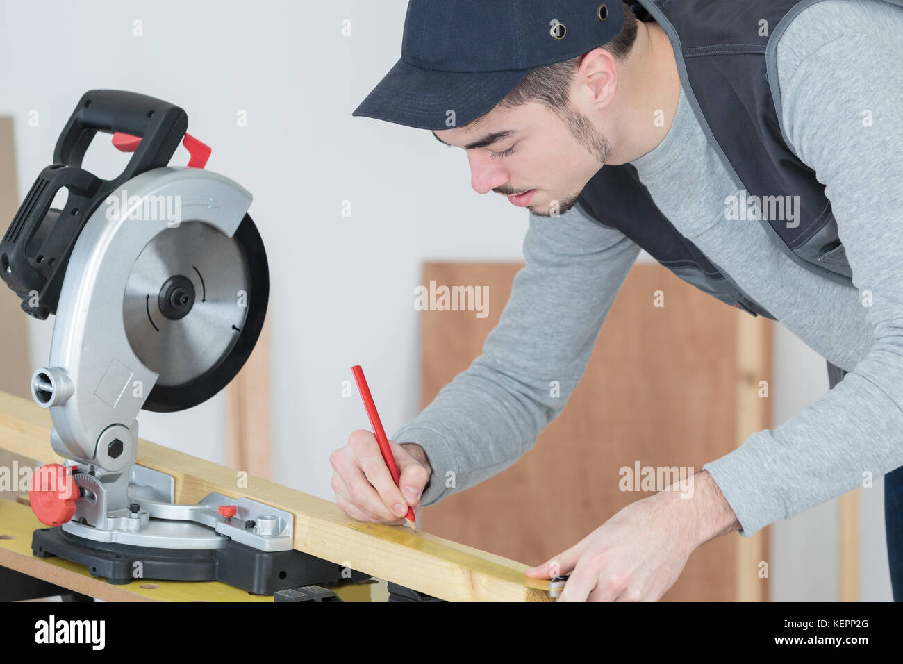 Worker marking wood Stock Photo - Alamy