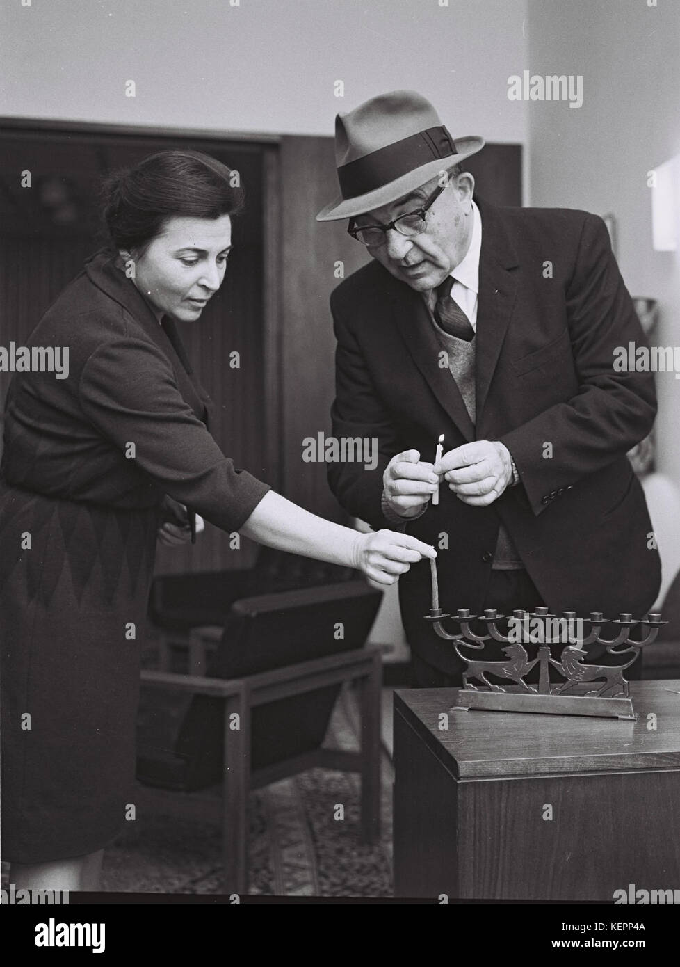 P.M. Levy Eshkol assisted by Mrs. Miriam Eshkol lighting the first ...